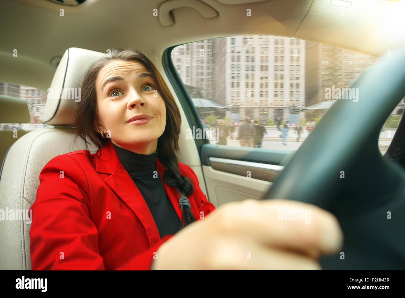 Driving around city. Young attractive woman driving a car Stock Photo ...