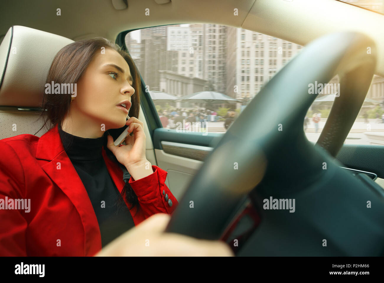 Driving around city. Young attractive woman driving a car Stock Photo ...