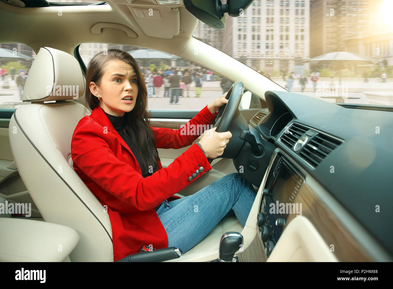 Driving around city. Young attractive woman driving a car Stock Photo ...