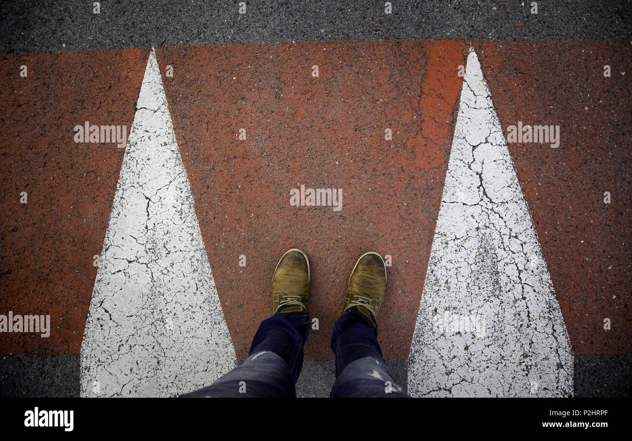 Feet in a zebra crossing, signal detail for pedestrians Stock Photo - Alamy