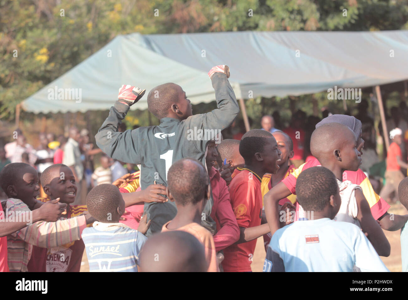 Children jubilating after a sweet victory in a football match in Moroto ...