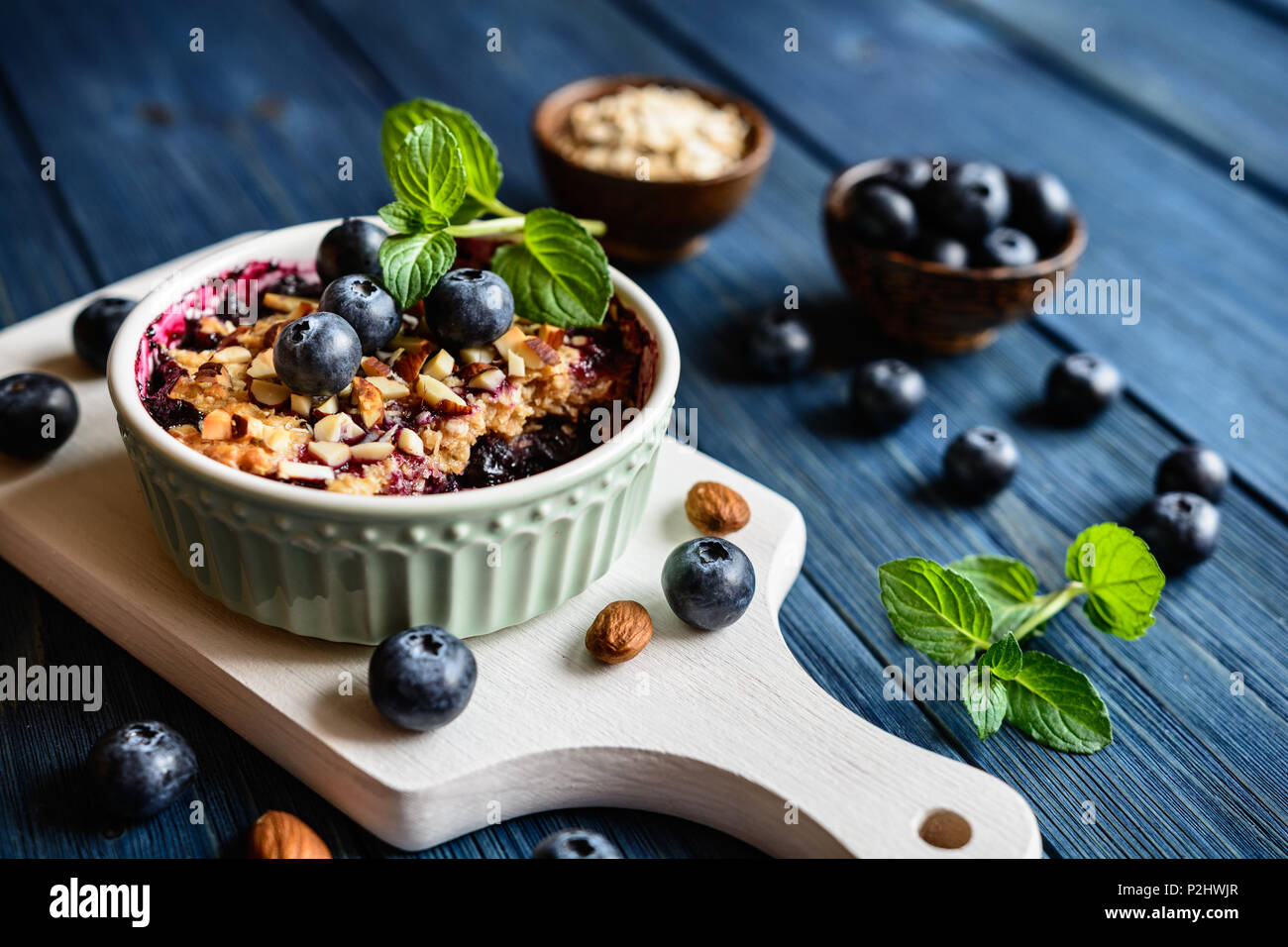 Baked blueberry crumble with oat flakes and chopped almonds Stock Photo ...