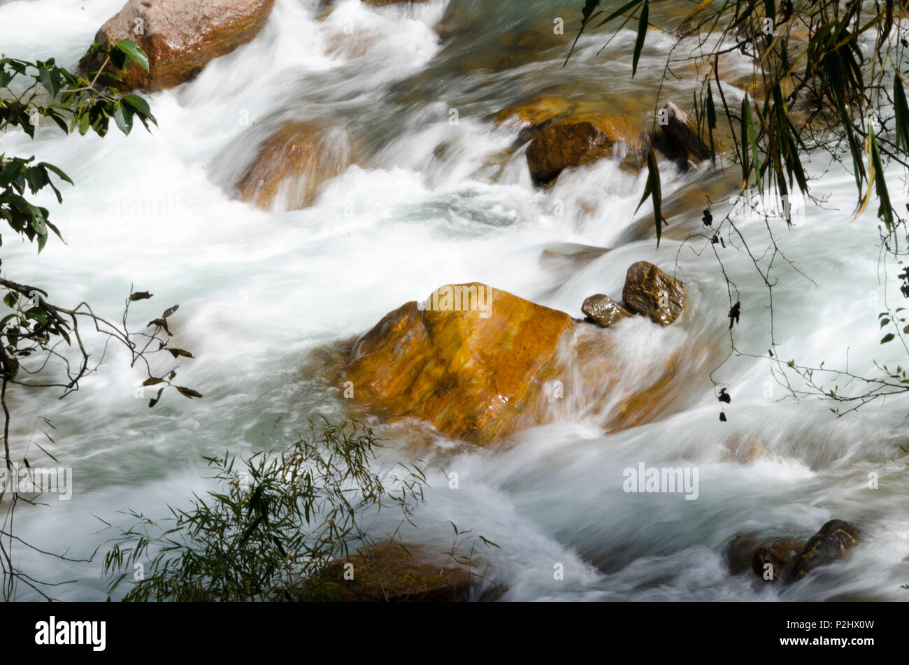 Rock in rapids in river near, Bamboo Lodge, Langtang Valley, Nepal ...