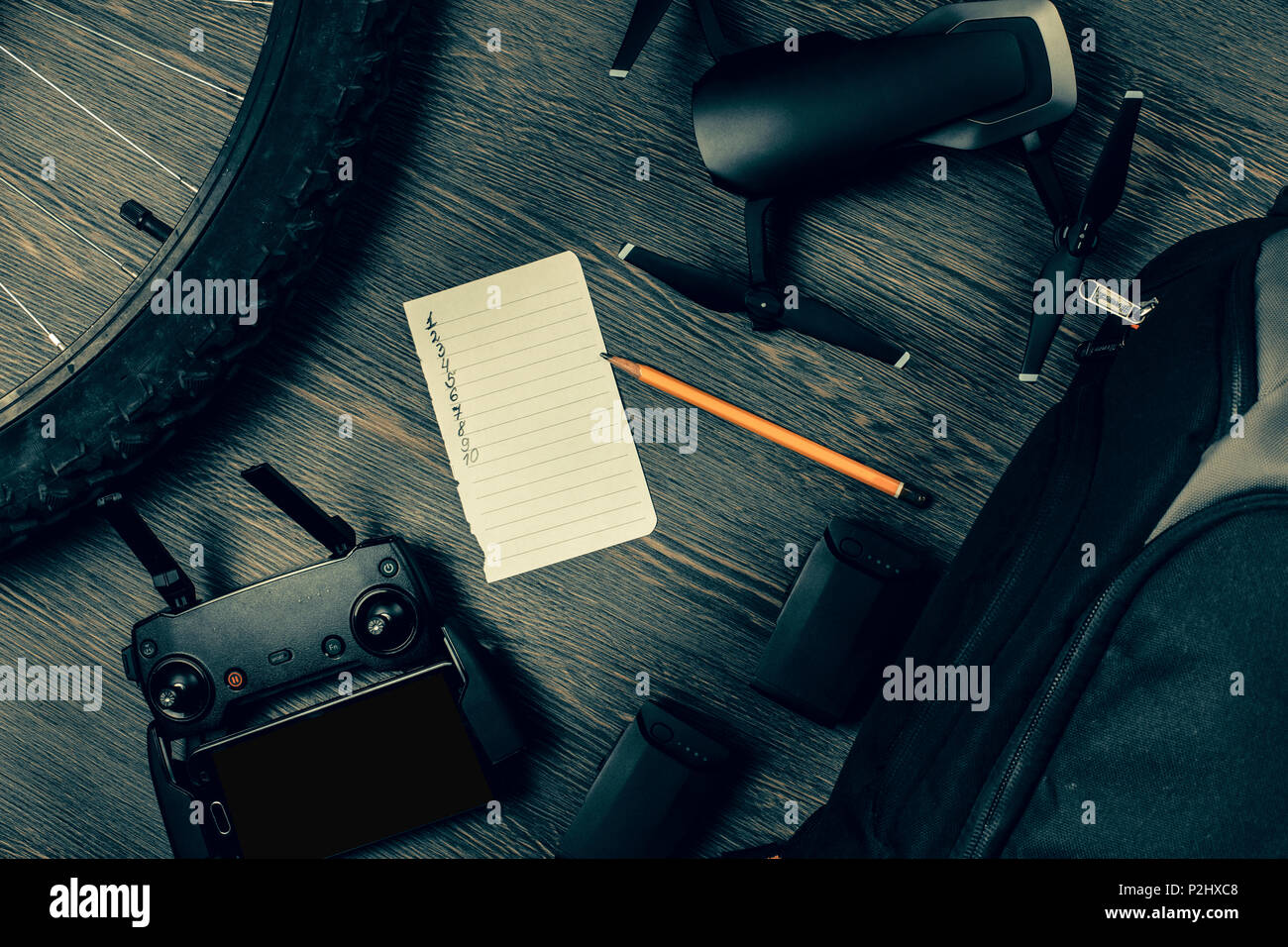 drone and its accessories on a wooden background near a bicycle sheet ...