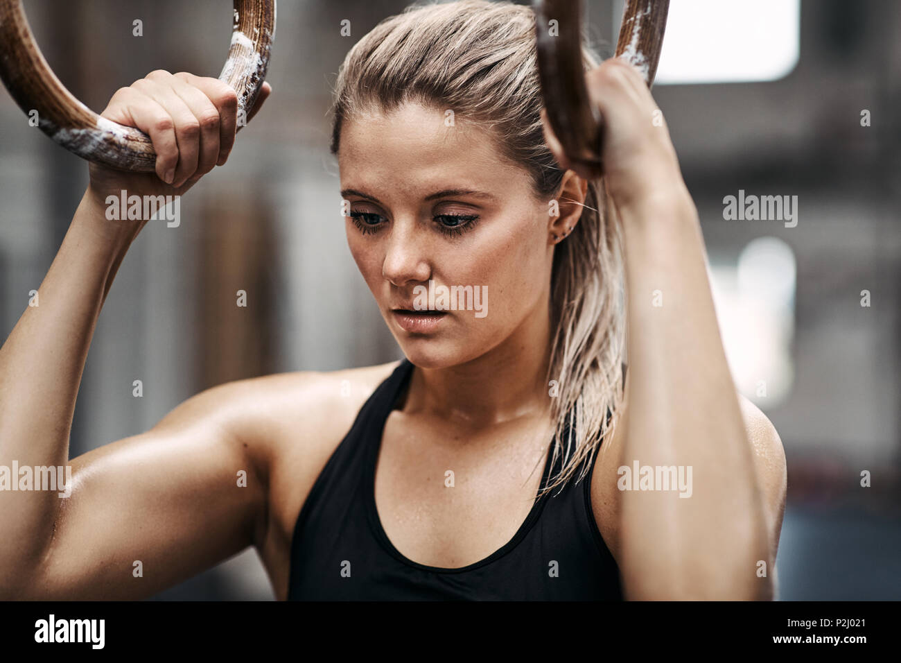 Fit young woman in sportswear getting focused before working out on ...