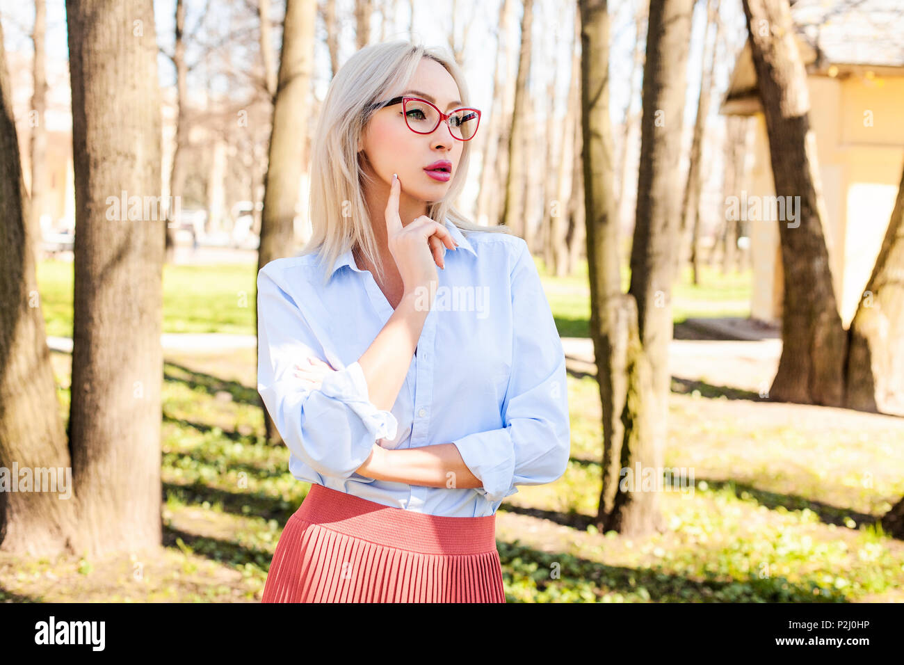 Thinking woman outdoors, portrait Stock Photo - Alamy