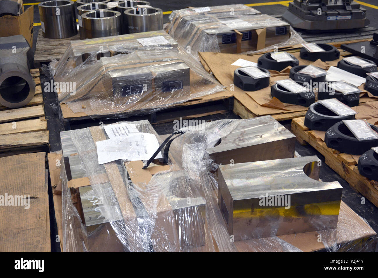 Several 120mm Abrams tank breech block forgings in the foreground have ...