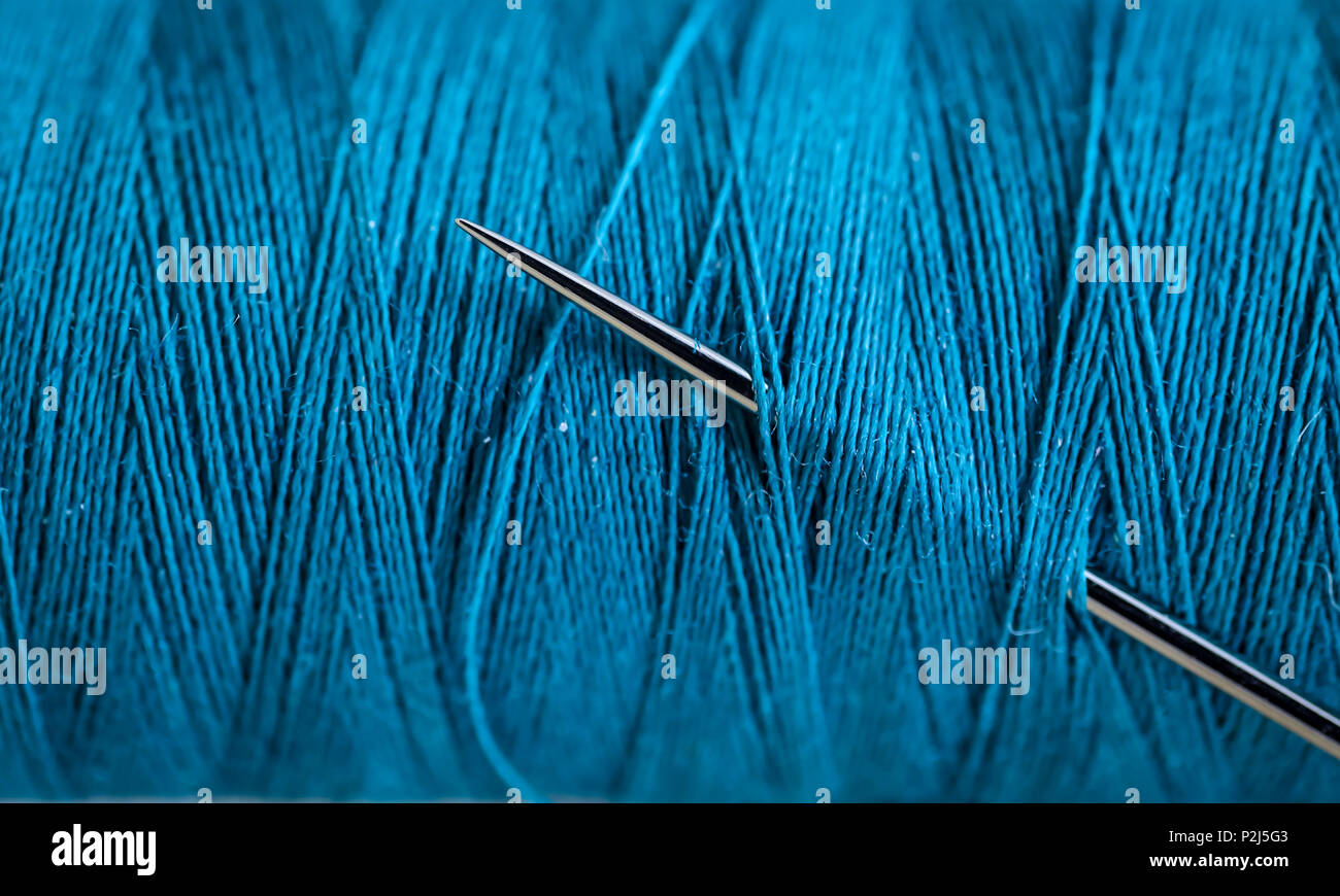 Sewing thread beautiful colors with needle closeup Stock Photo - Alamy