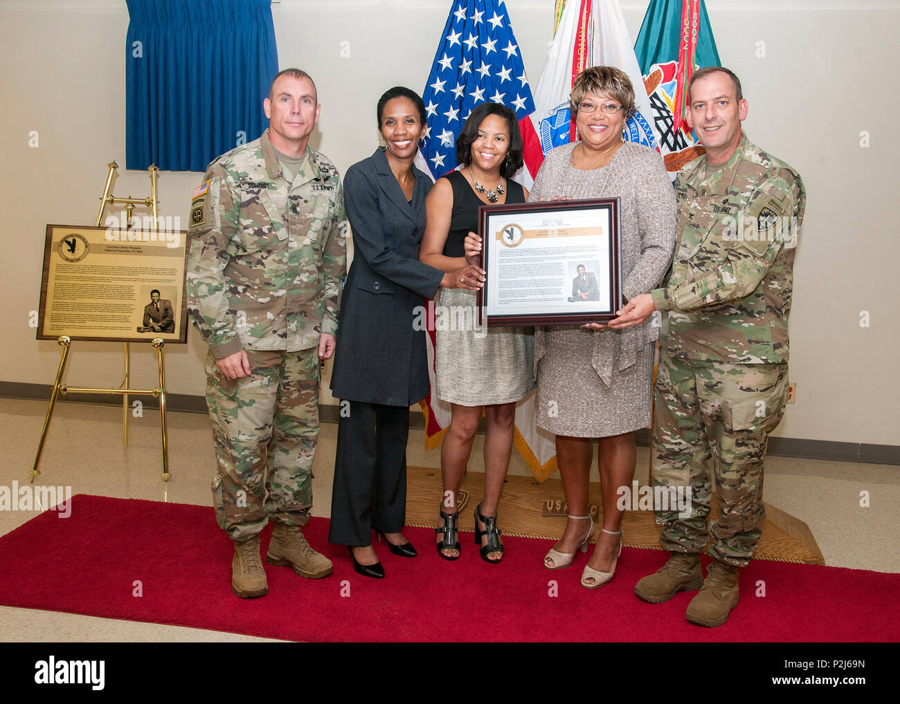 Posing with a replica wall plaque are (from left to right) OTC Command ...