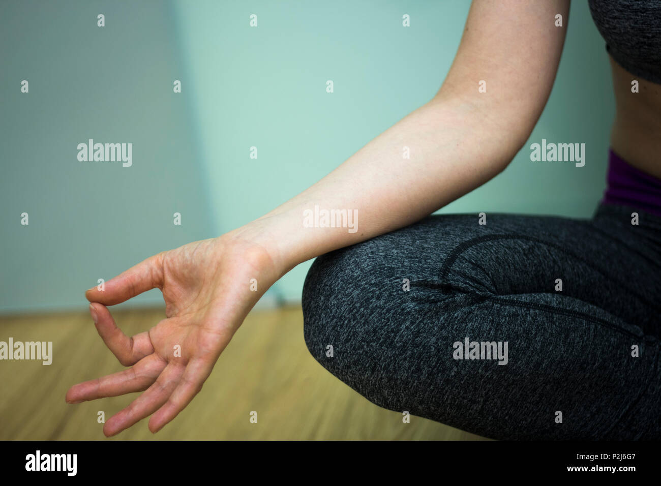 Female instructor yoga teacher teaching asana pose with mudra hand ...