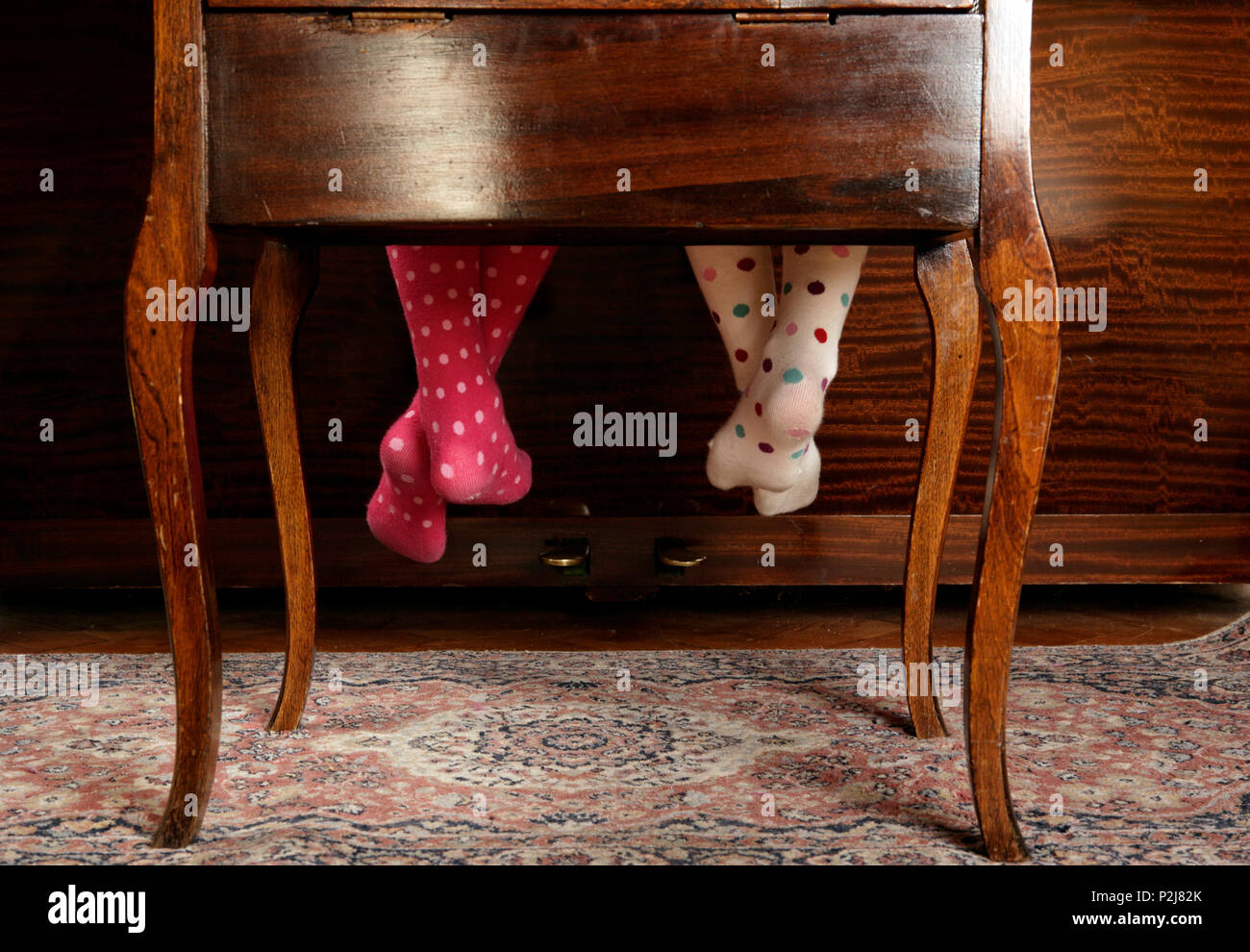 Piano duet, two young girls legs on a piano stool Stock Photo - Alamy