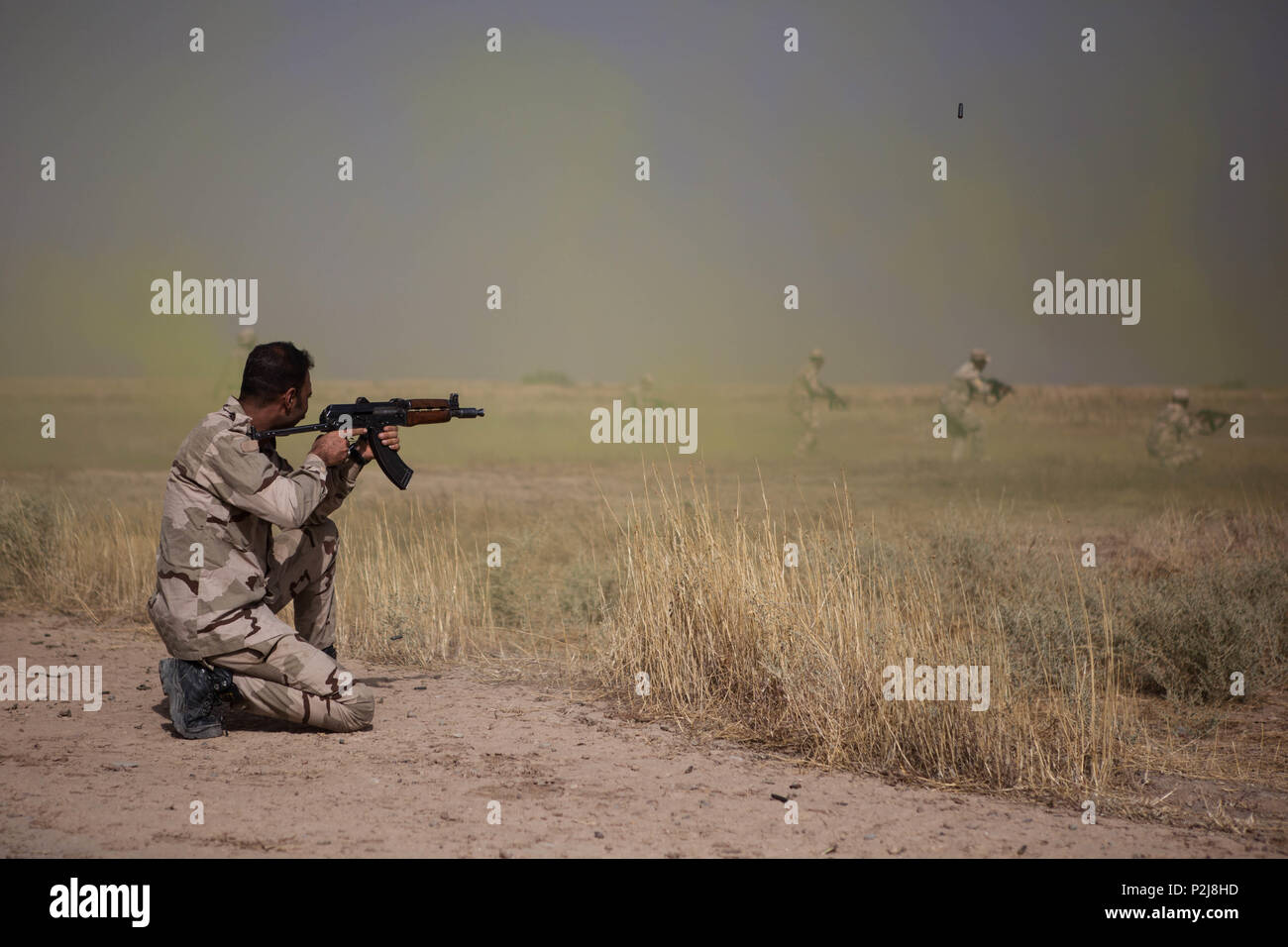 An Iraqi soldier covers his fellow soldiers during squad battle drills ...