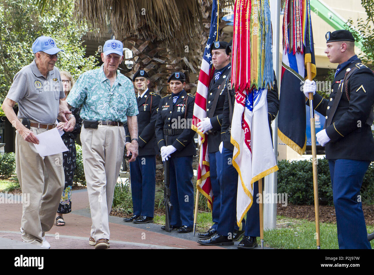 World War II veterans Jay Johnston and John Pigott walk in front of the ...