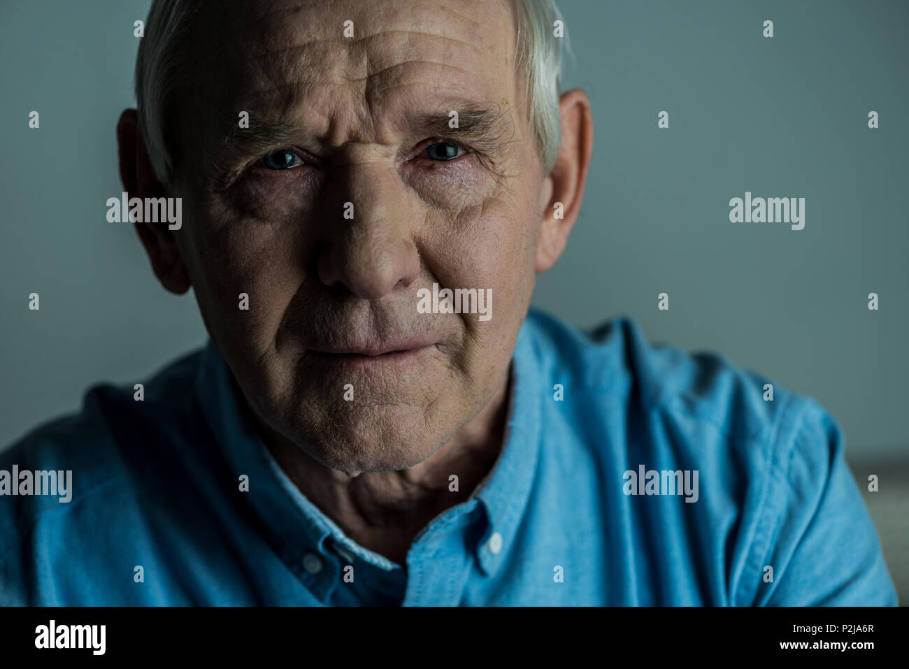 Sad retired male looking camera hi-res stock photography and images - Alamy