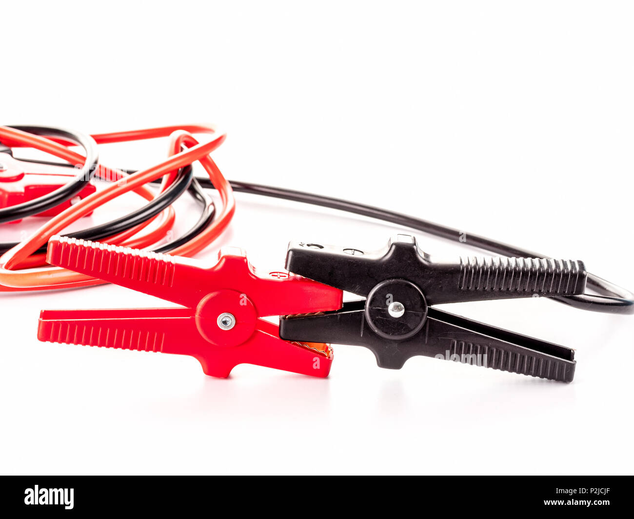 Black and red twisted jumper cables shot over white Stock Photo - Alamy