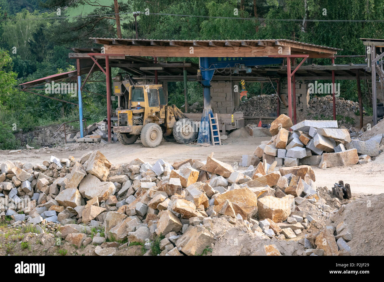 Mining in the granite quarry. Working mining machine - old digger ...