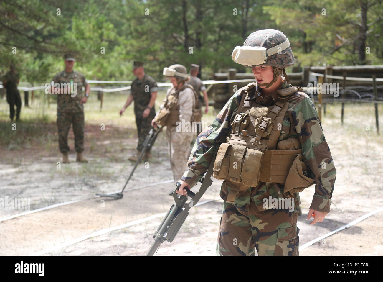 Jenny Dibble, spouse of Capt. Dibble, uses a metal detector to scan for ...