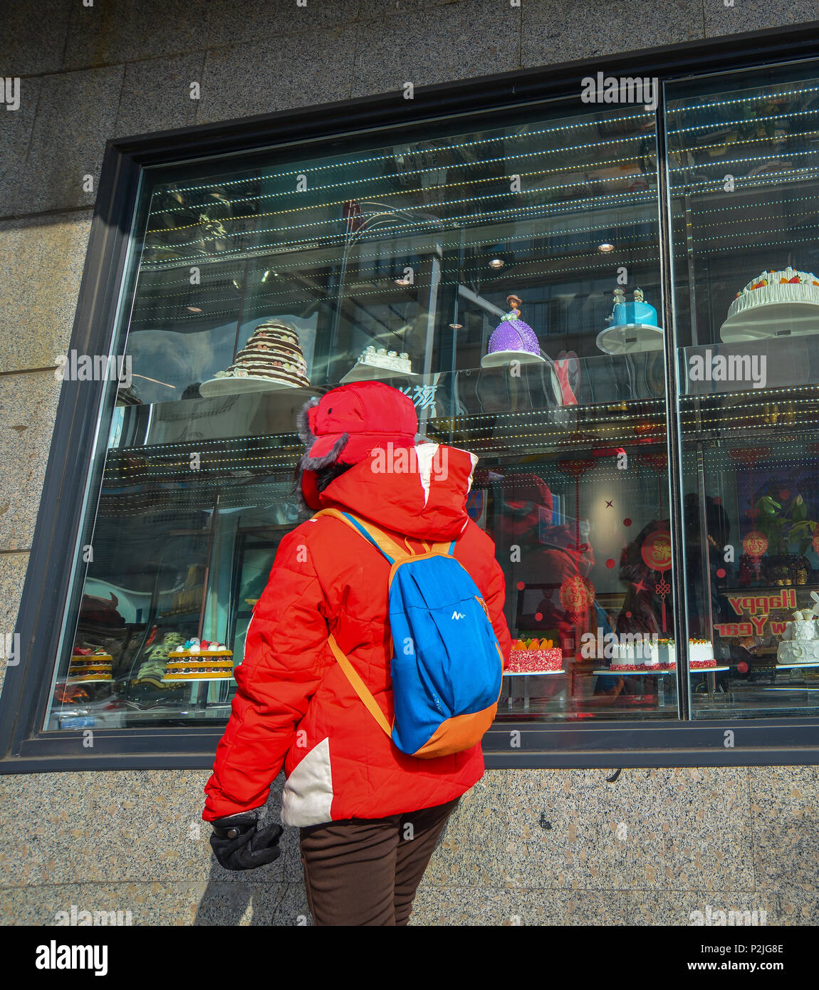 Harbin, China - Feb 22, 2018. A woman walking on street in Harbin ...