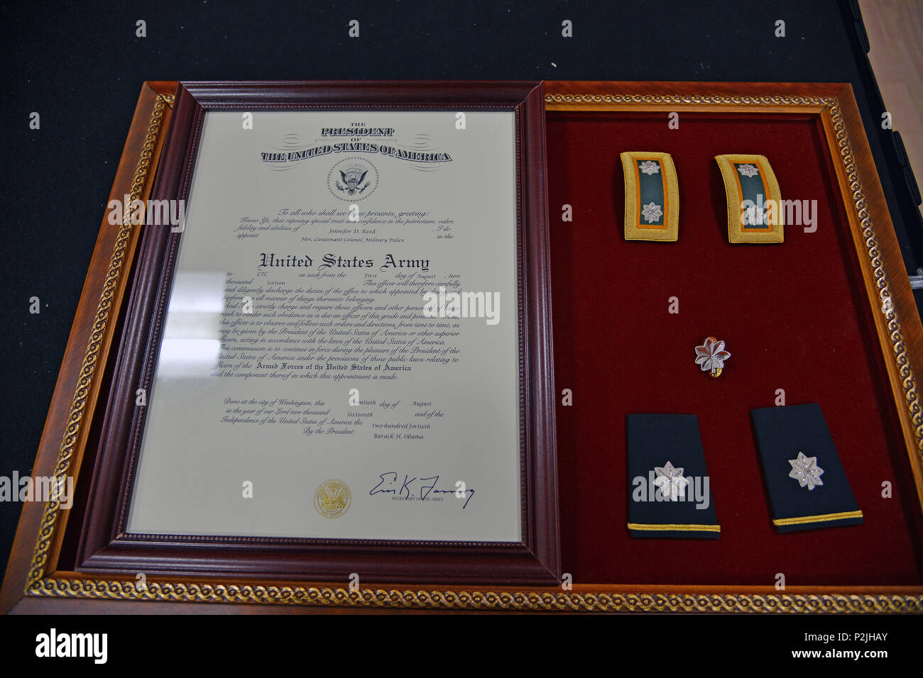 A lieutenant colonel rank and framed commissioning decree are placed on ...