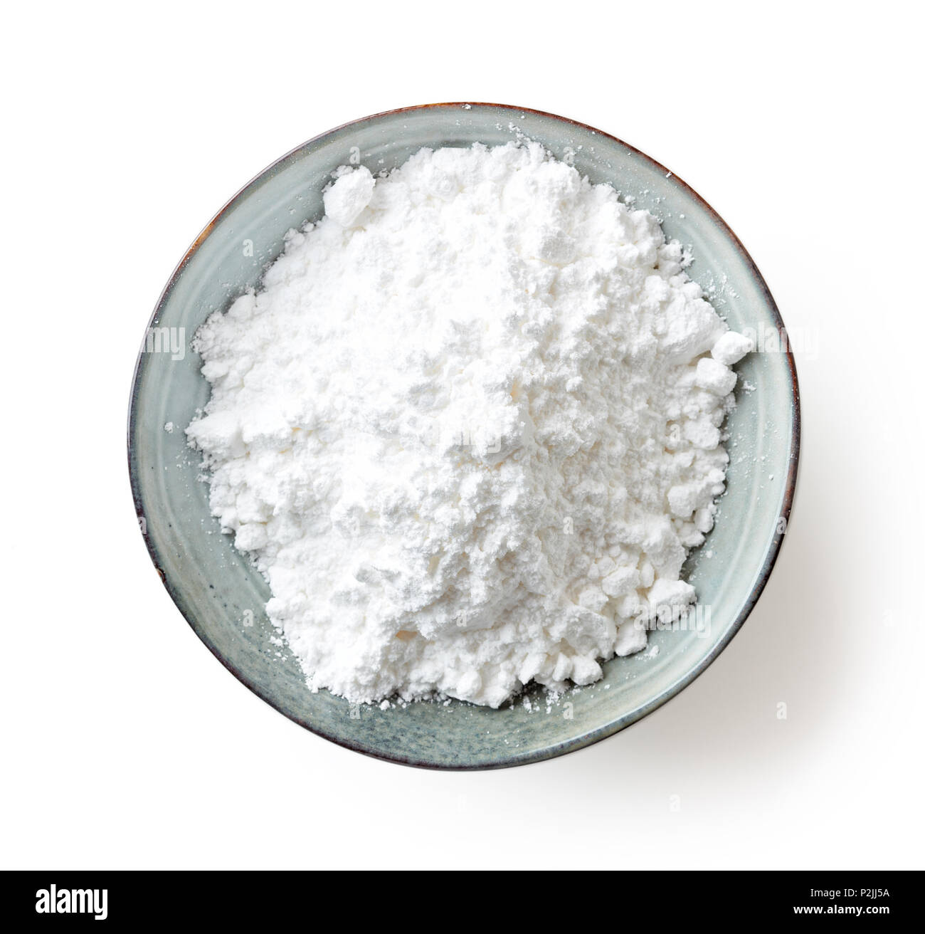 Bowl of powder sugar isolated on white background, top view Stock Photo ...