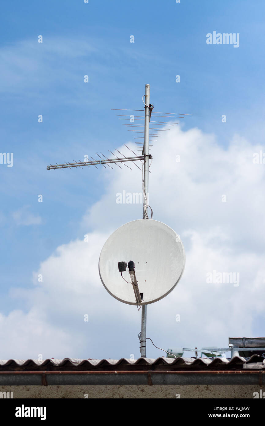 White satellite dish on an old roof top Stock Photo - Alamy