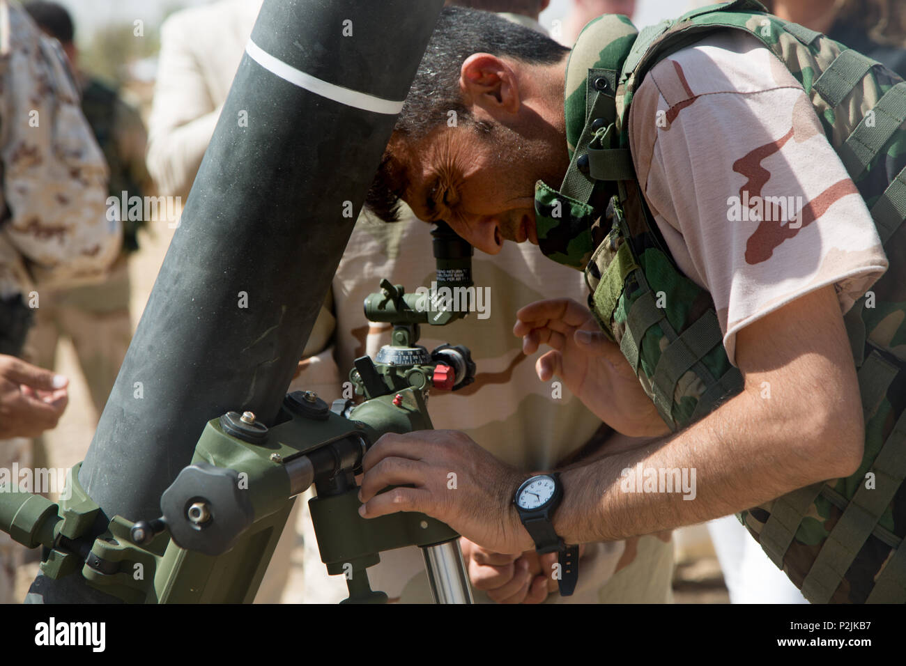 A Peshmerga soldier checks the sight on a M120 120mm mortar system ...