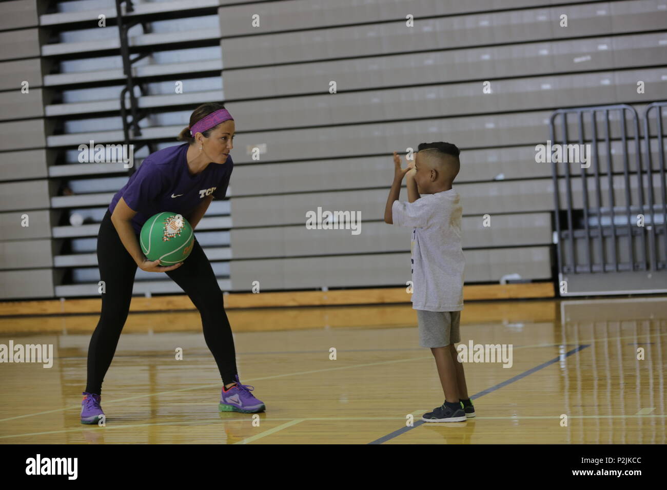Hanna Howard works with a young basketball player at the WBCA Hoops ...