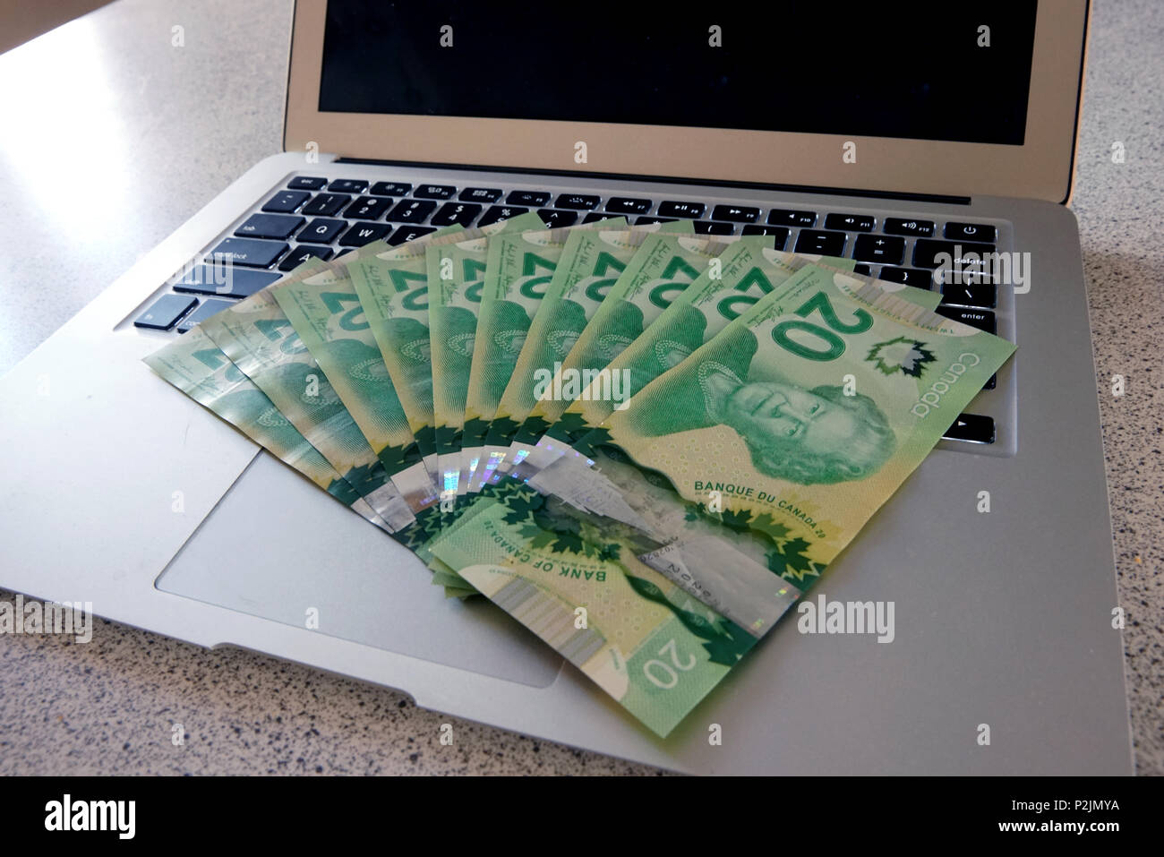 Laptop and money hi-res stock photography and images - Alamy