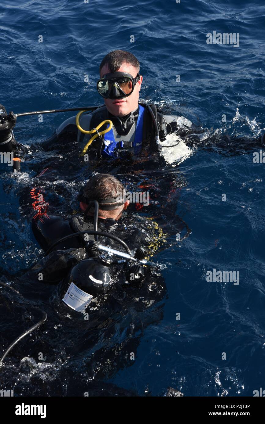 U.S. Army Capt. Troy Davidson, background, team leader, and Sgt. 1st ...
