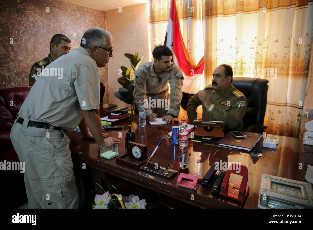 A U.S Marine assigned to Task Force Taqaddum discuss future operations ...