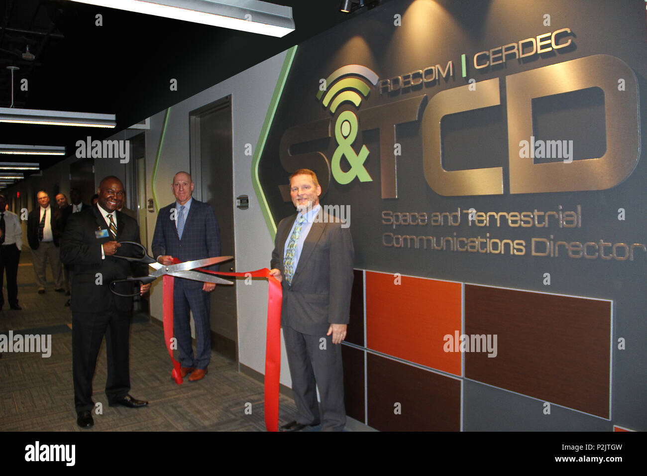 Dr. McKinney, John Willison and Donald Heckman cut the ribbon to ...