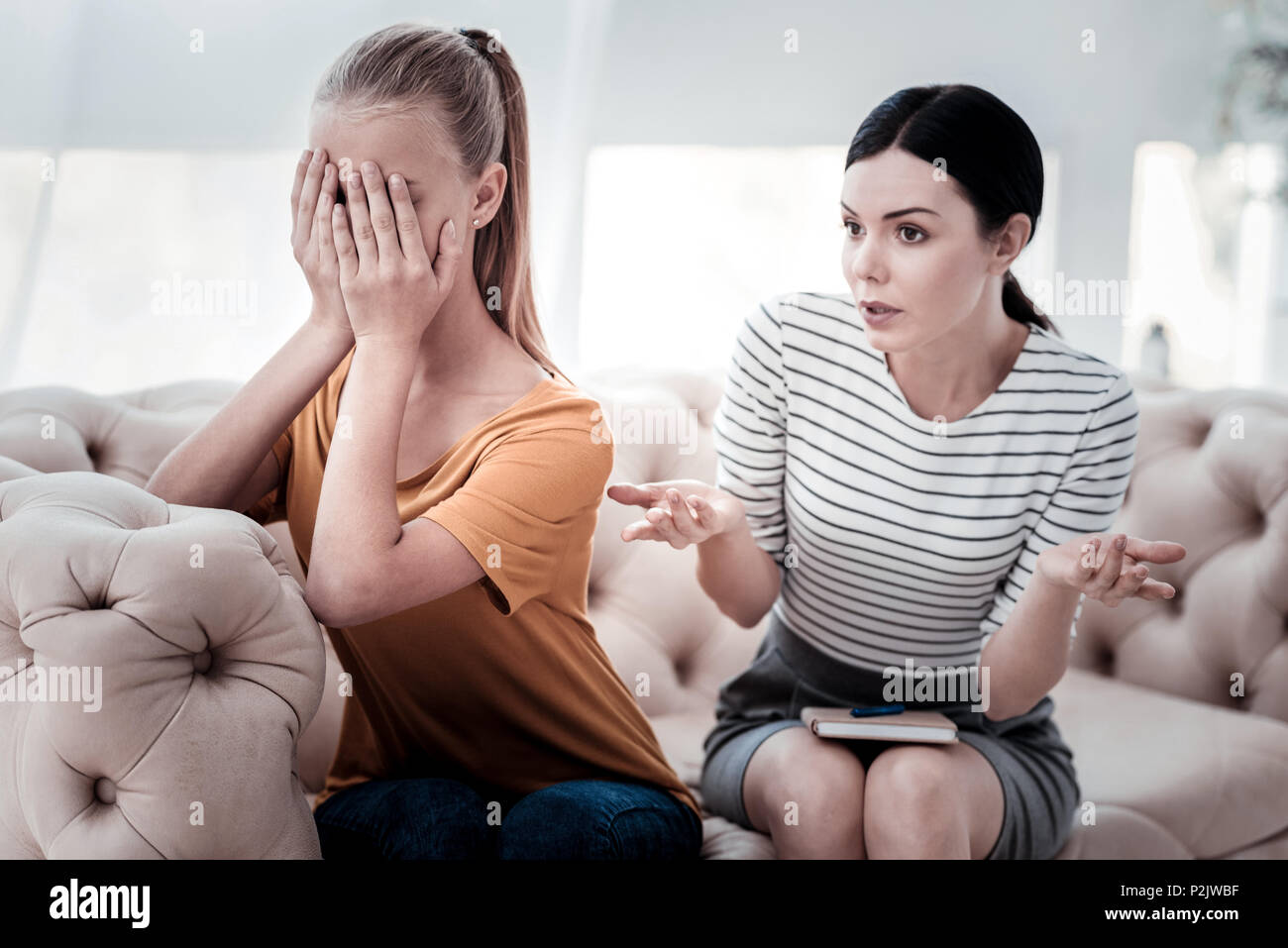 Portrait of disappointed girl visiting a psychologist Stock Photo - Alamy