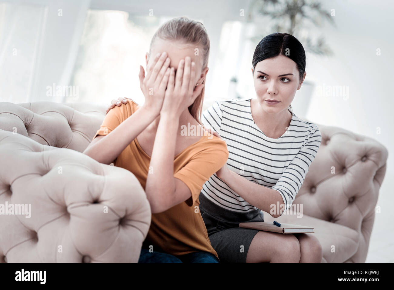 Portrait of sad girl keeping hands on her face Stock Photo - Alamy