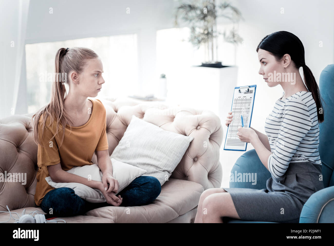 Confused girl looking at her test results presented by psychologist ...