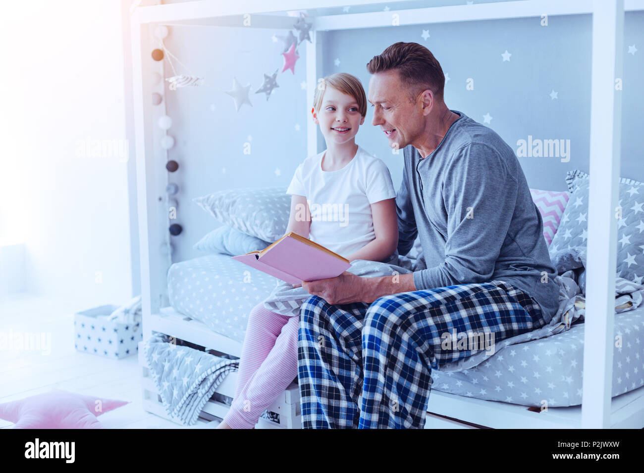 Thoughtful father reading fairytale for his daughter Stock Photo - Alamy