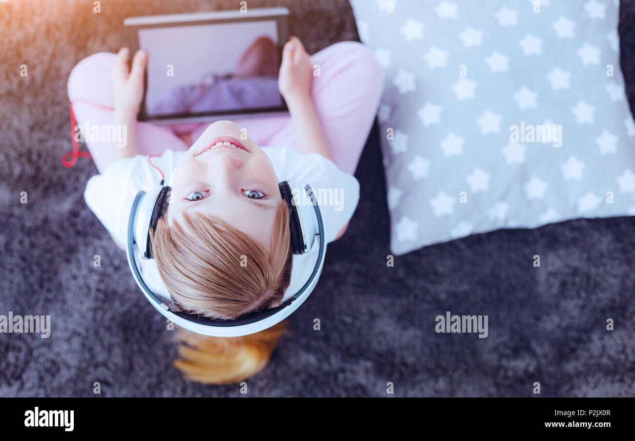 Smiling girl with tablet computer smiling into camera Stock Photo - Alamy
