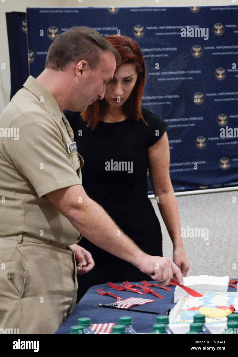 (Left to right) CDR Michael Marcolla and his wife, Farah, cut his ...