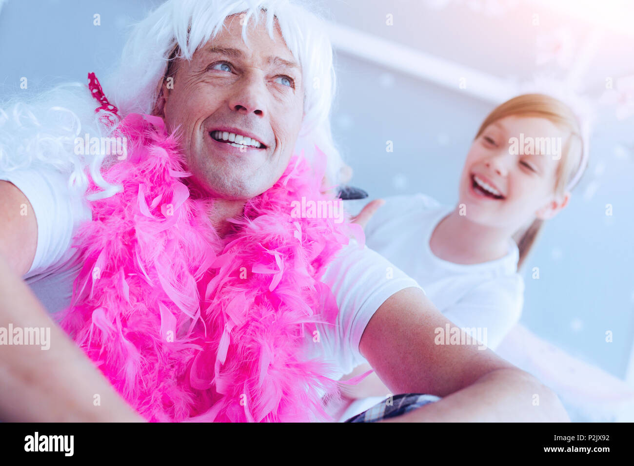 Radiant family members having fun and playing Stock Photo - Alamy
