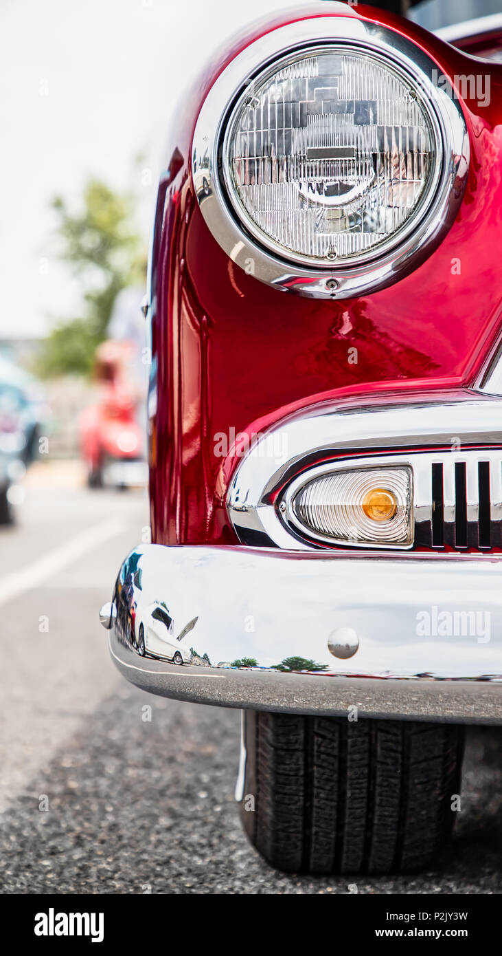 The headlight and chromed front end of an early fifties classic ...