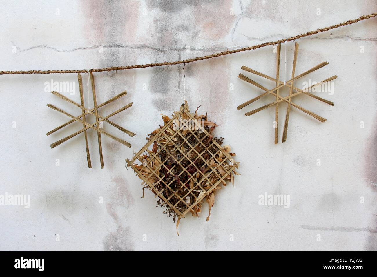 Closeup of cute wicker wooden wreath made of dried branch and leaves ...