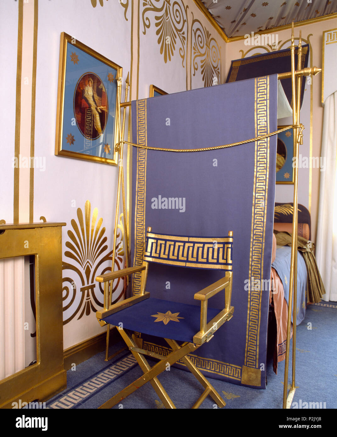 Gold-painted director's chair with gold Greek key design on purple ...