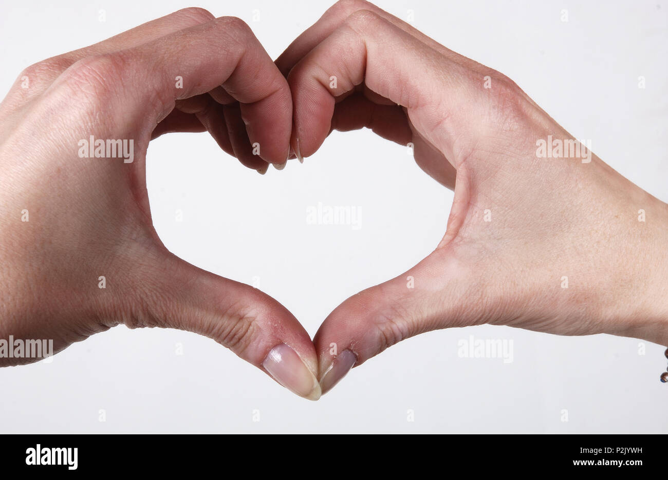 Woman making heart shape with her hands Stock Photo - Alamy
