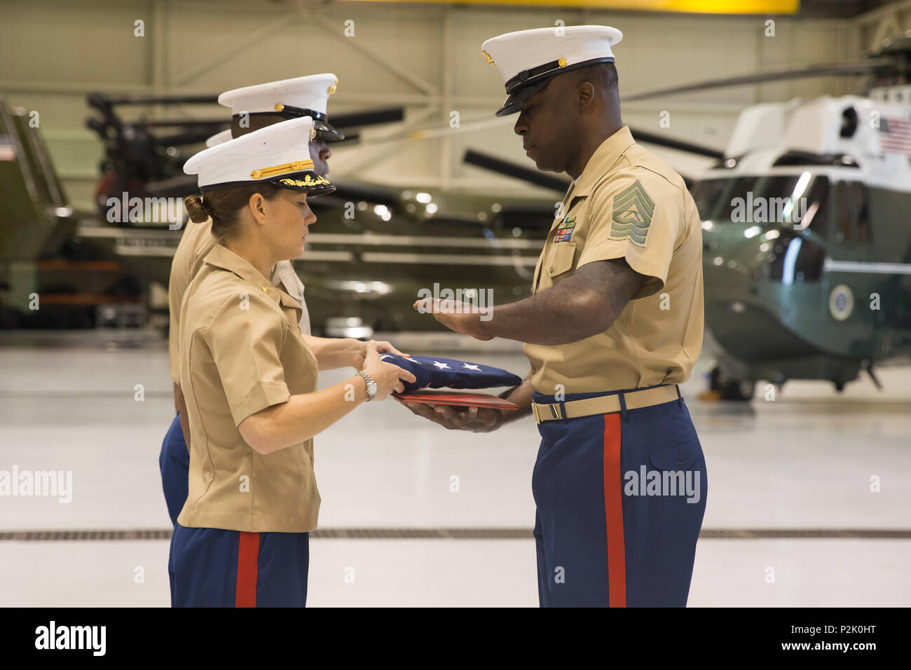 U.S. Marine Corps Master Sgt. Anthony Colston accepts the national flag ...