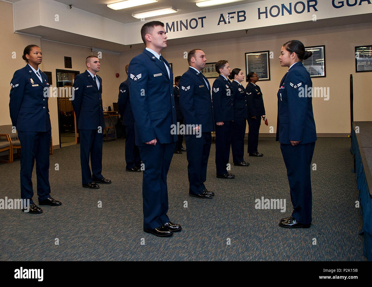 Airmen with the Minot Air Force Base Honor Guard perform an open ranks ...