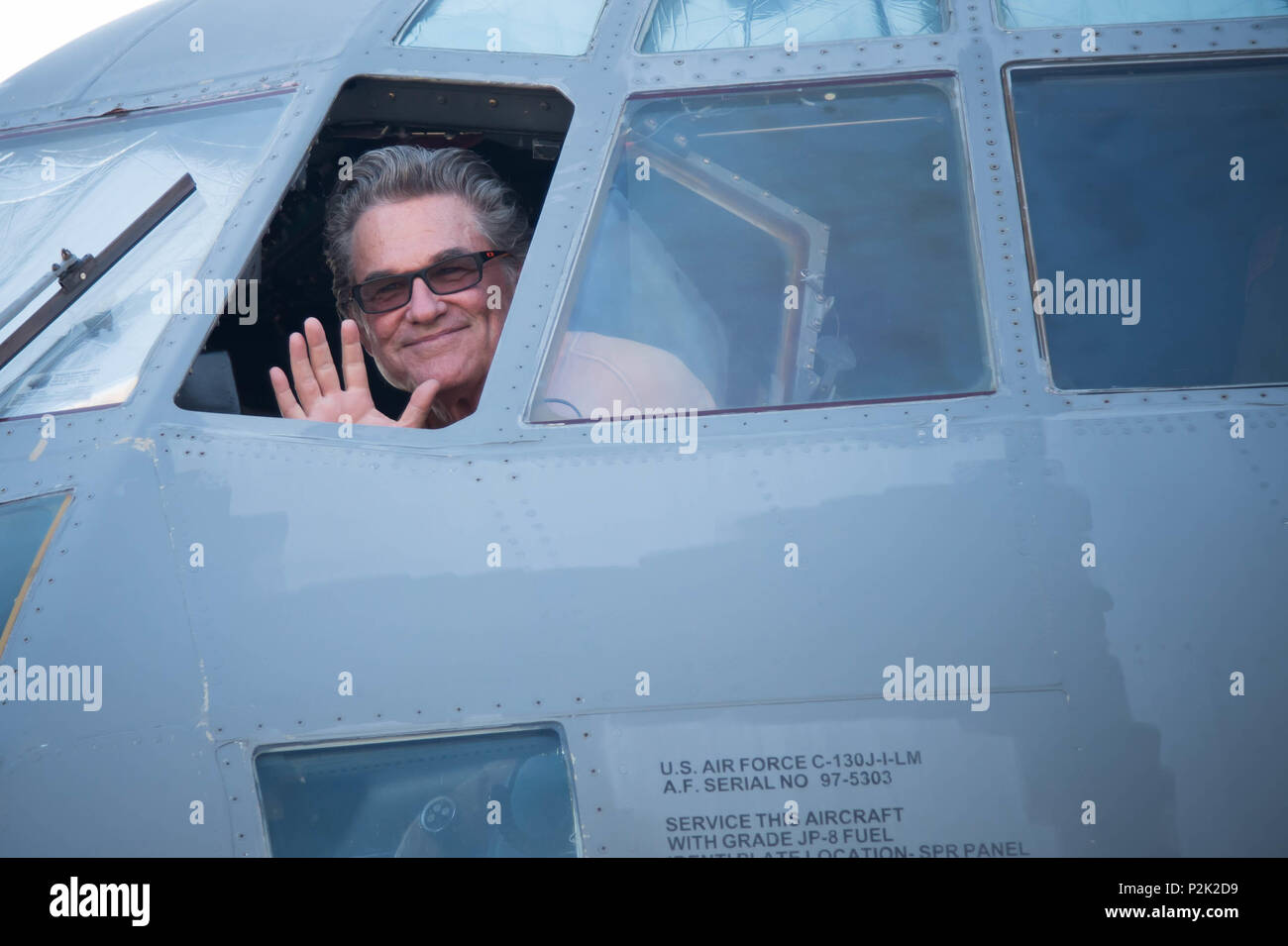 Actor Kurt Russell waves out the window of a WC-130J Super Hercules ...