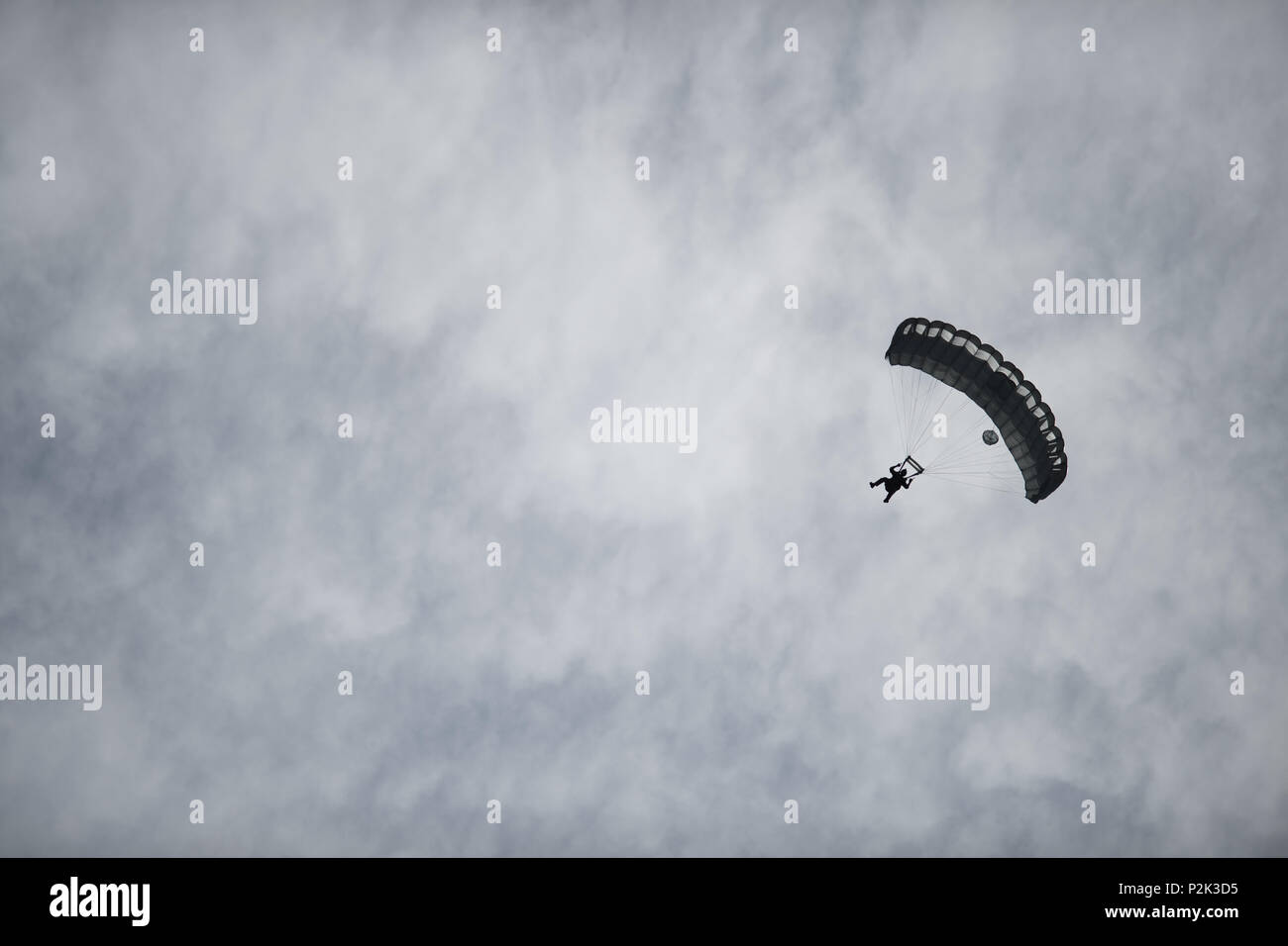 A pararescueman (PJ) glides through the air during a high-altitude, low ...