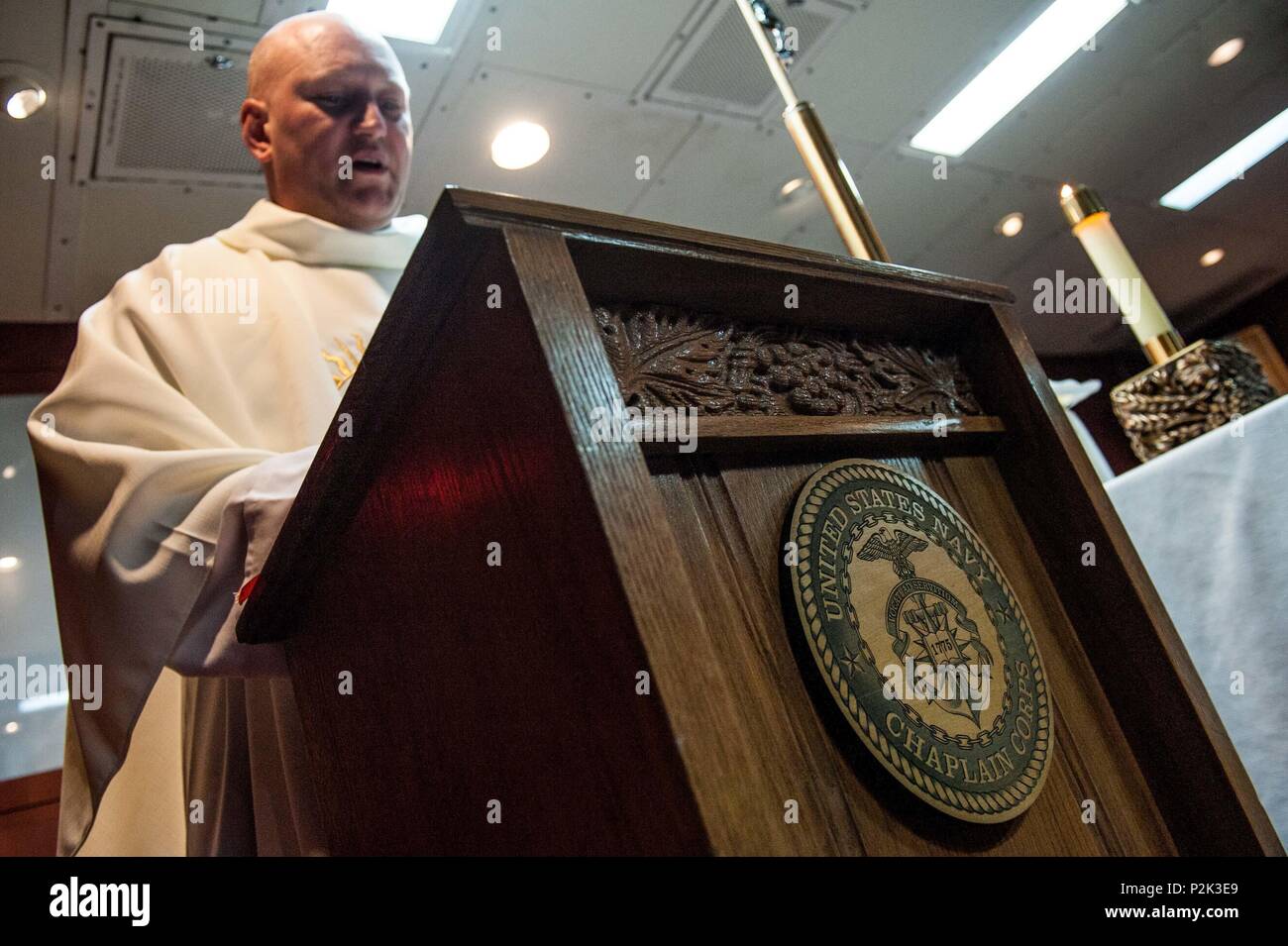 Lt. j.g. Jason Burchell, a Navy chaplain, performs roman catholic mass ...