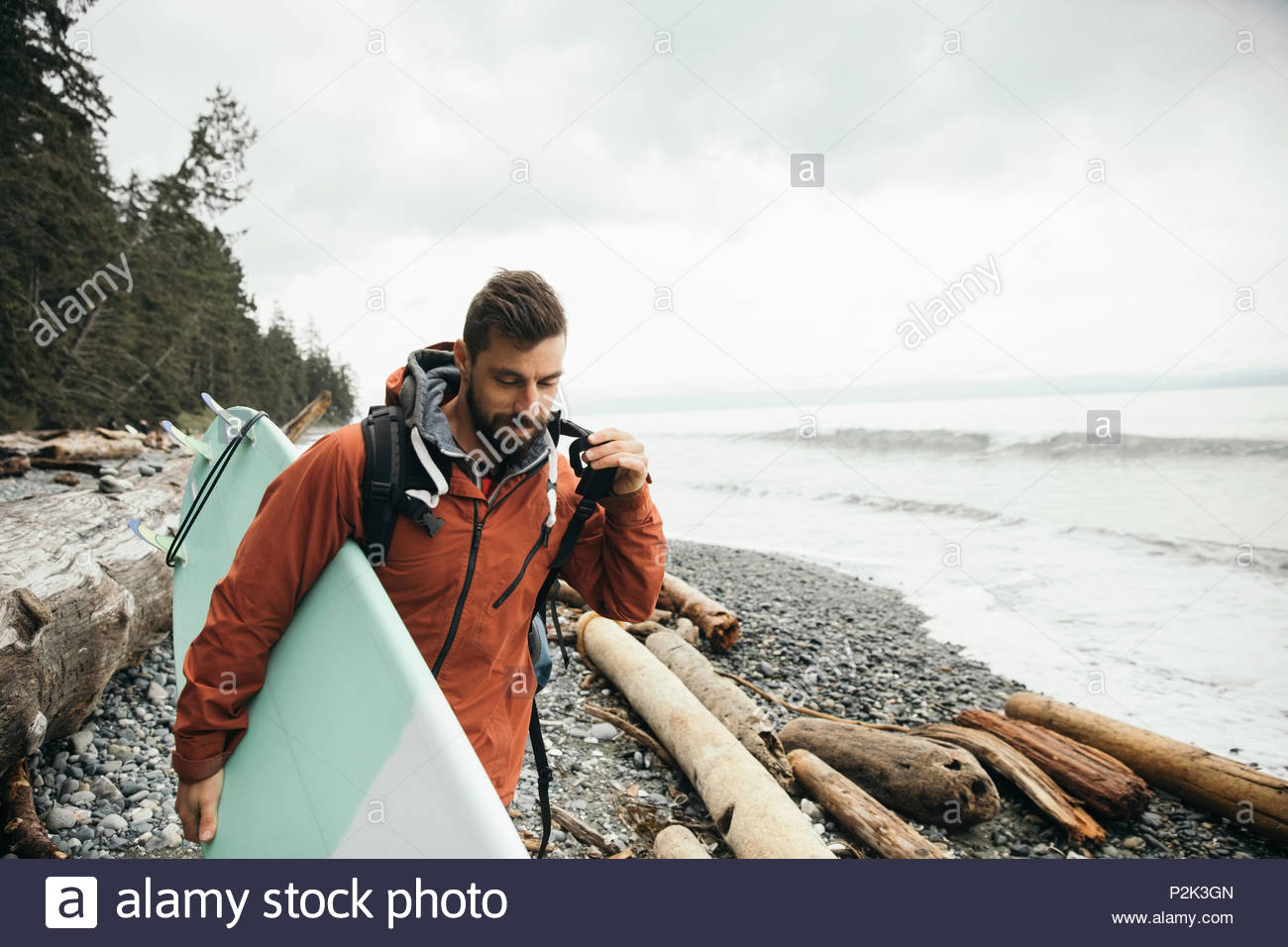 Man with surfboard on beach hi-res stock photography and images - Alamy