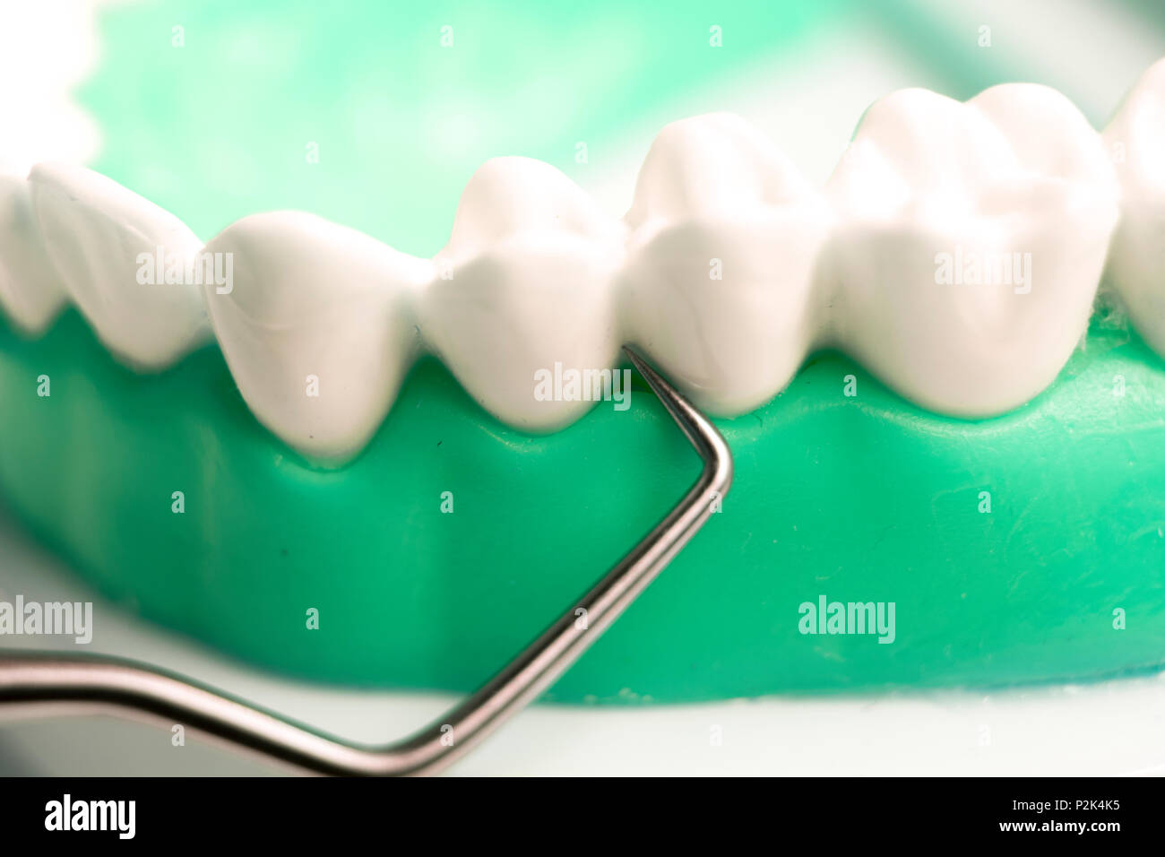 Dentist cleaning teeth with titanium metal tooth pick instrument to ...