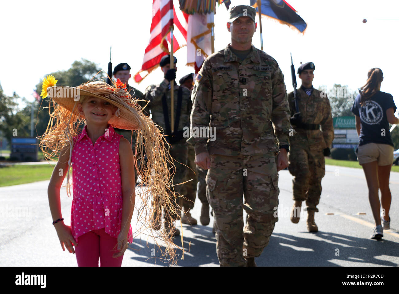 A young girl poses in front of Capt. Thomas Olmstead, commander of ...
